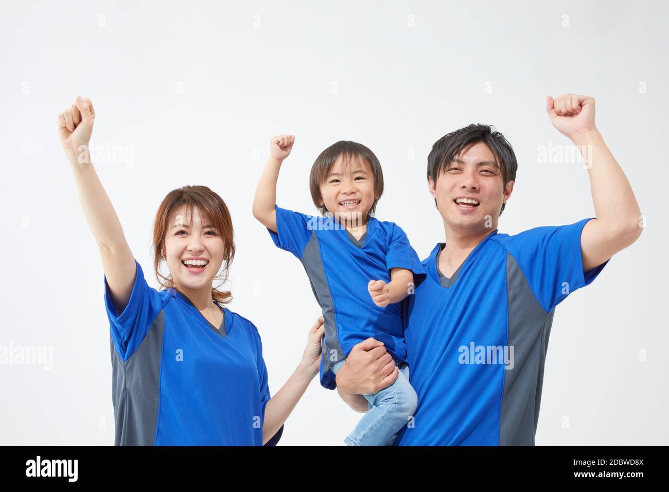 Family Watching A Game And Cheering Stock Photo - Alamy