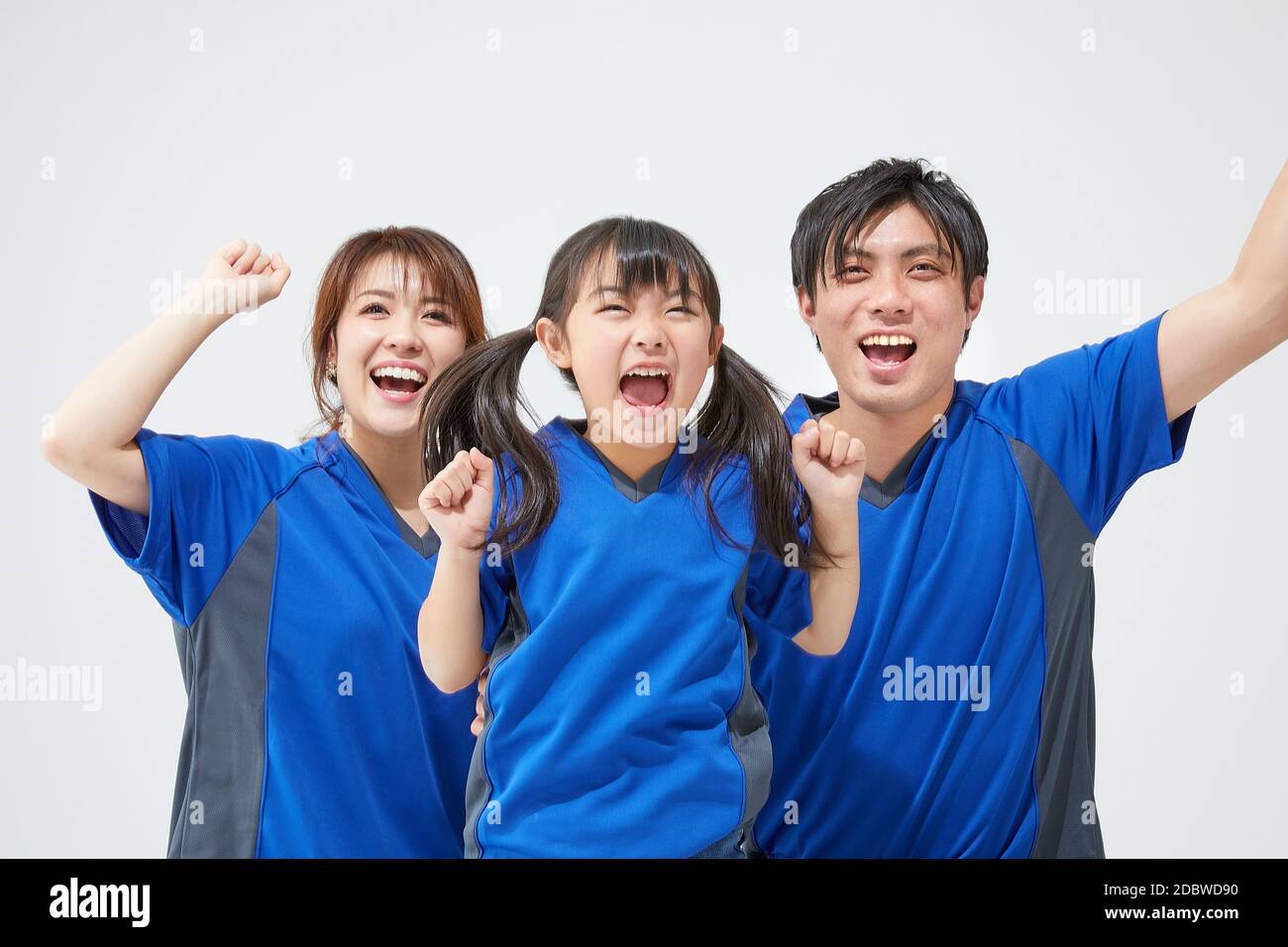 Family Watching A Game And Cheering Stock Photo - Alamy