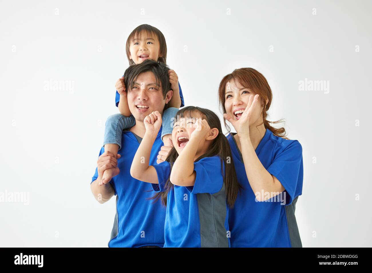Family Watching A Game And Cheering Stock Photo - Alamy