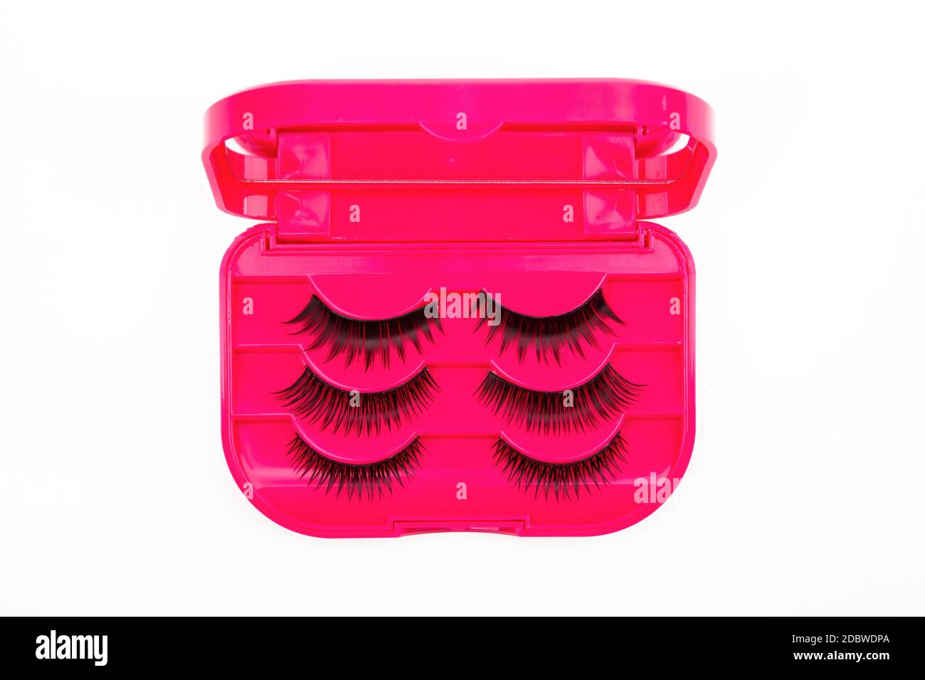 Eyelashes extensions in a pink plastic box isolated on white background ...