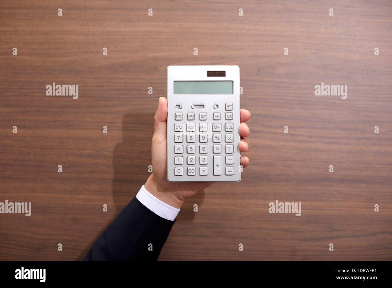 Hand Holding An Electronic Calculator Stock Photo - Alamy
