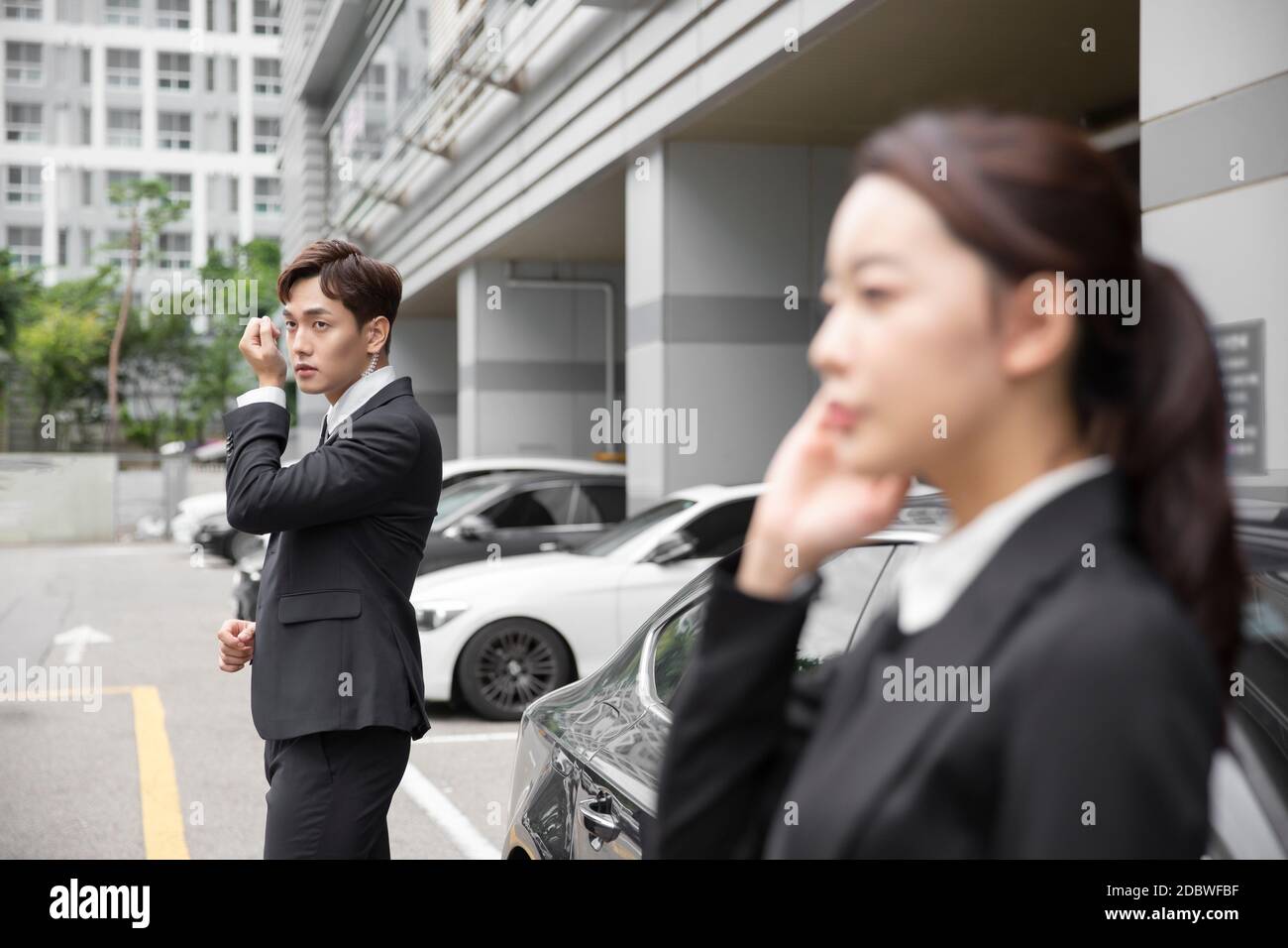 Asian male and female two security guards 045 Stock Photo - Alamy