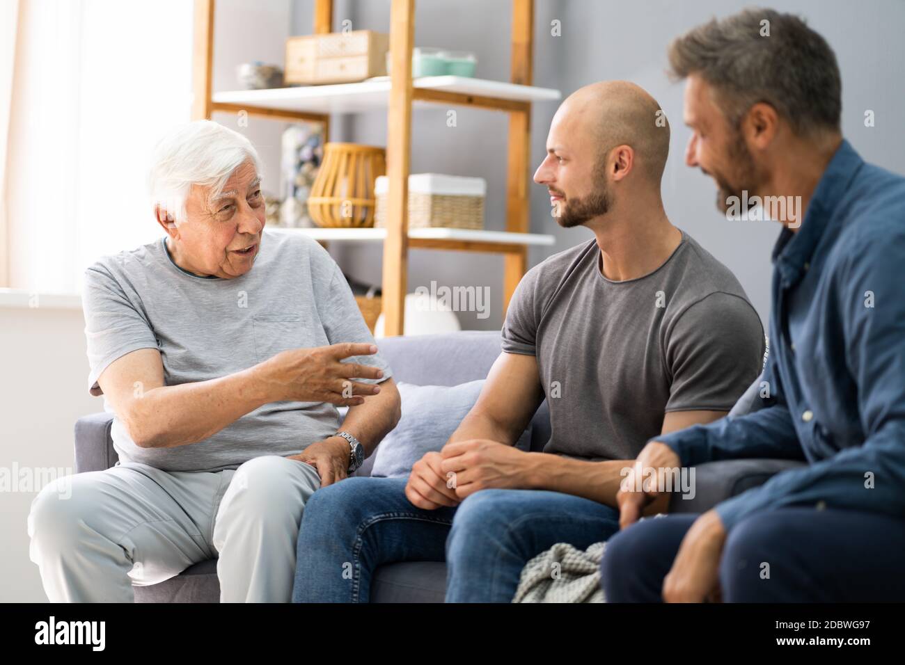 Grandpa Talking With Grandson And Son. Three Generations Family Stock ...