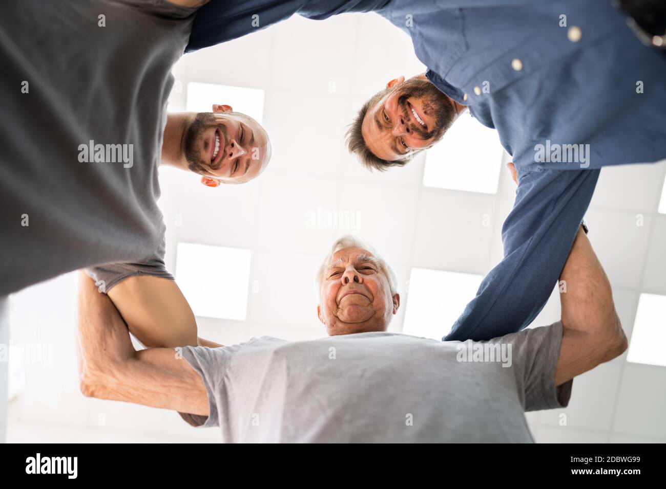 Three Generation Happy Men Standing Making Huddle Stock Photo - Alamy