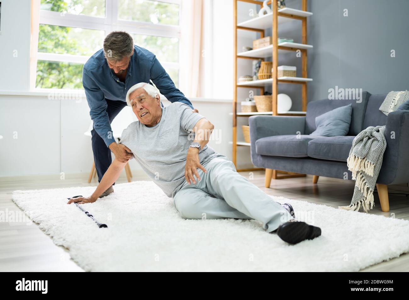 Helping Elder Senior Fallen Man After Fall Accident Stock Photo - Alamy