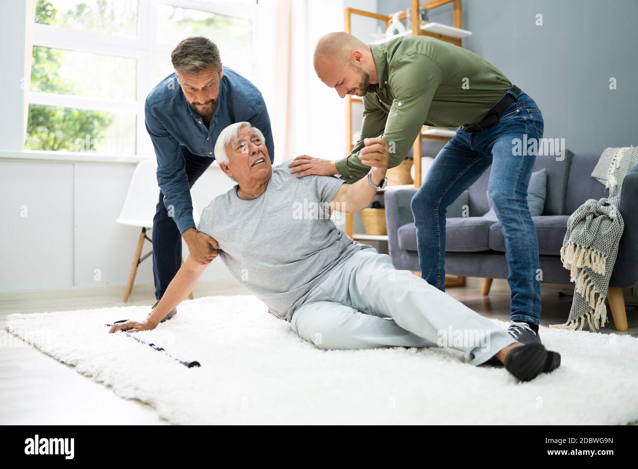 Helping Elder Senior Fallen Man After Fall Accident Stock Photo - Alamy
