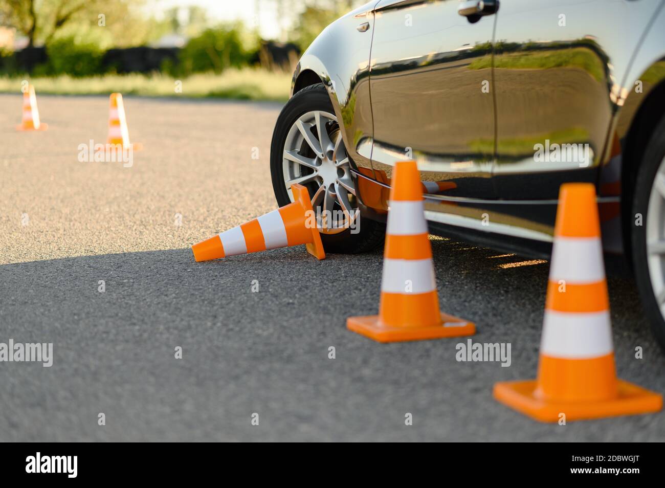 Car and downed traffic cone, lesson in driving school concept, nobody ...