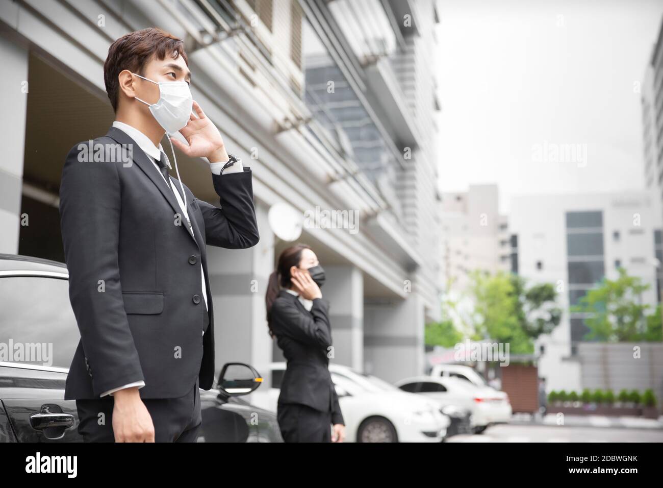 Asian male and female two security guards 052 Stock Photo - Alamy