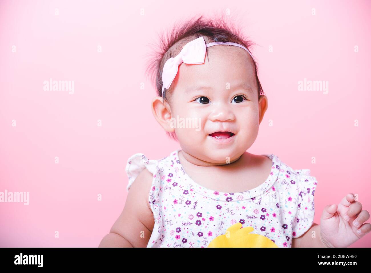 Portrait of Asian girl little cute baby smiling happy face on pink ...