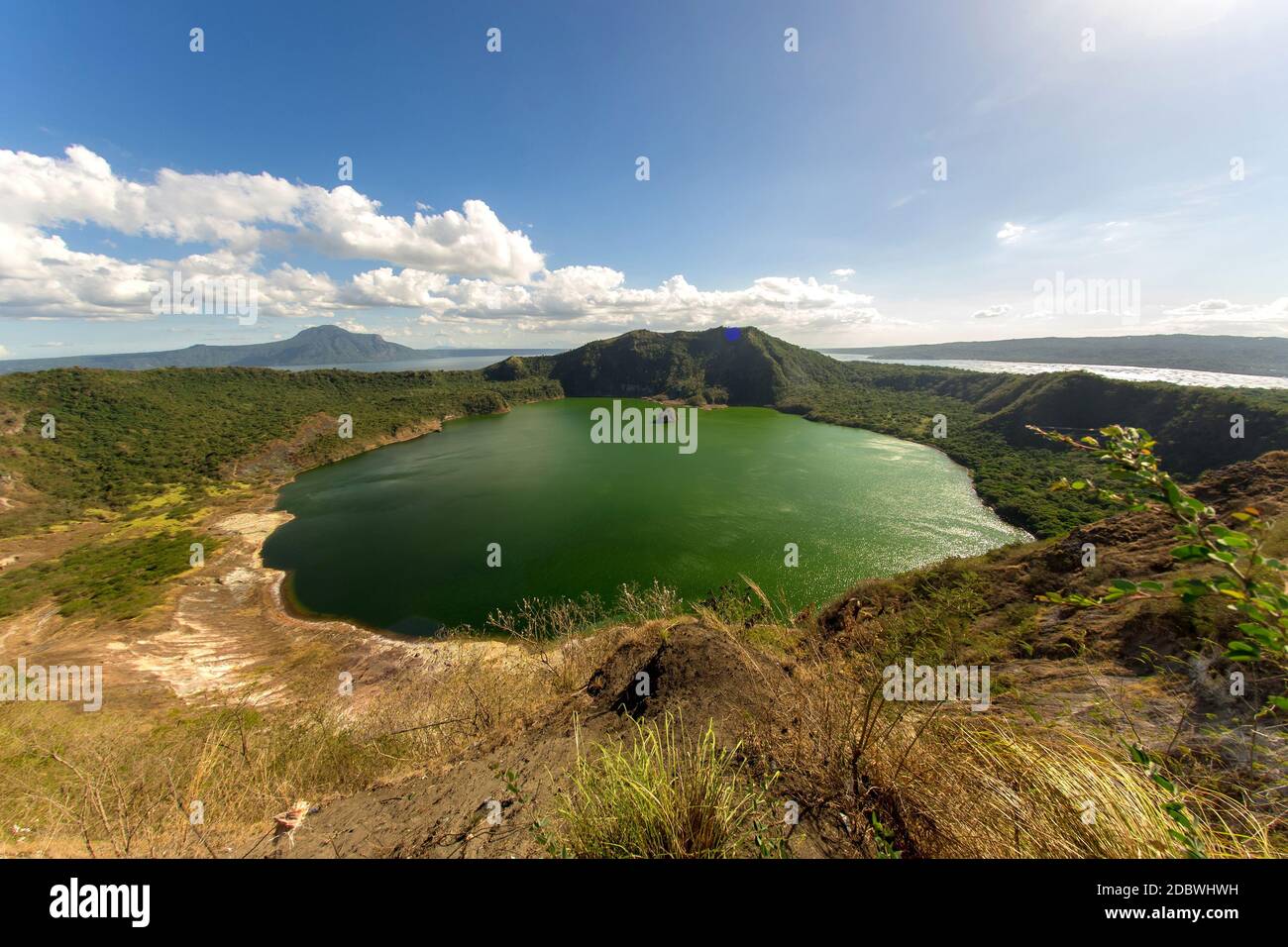 View of cones of Taal Volcano and the wind ruffled emerald green water ...