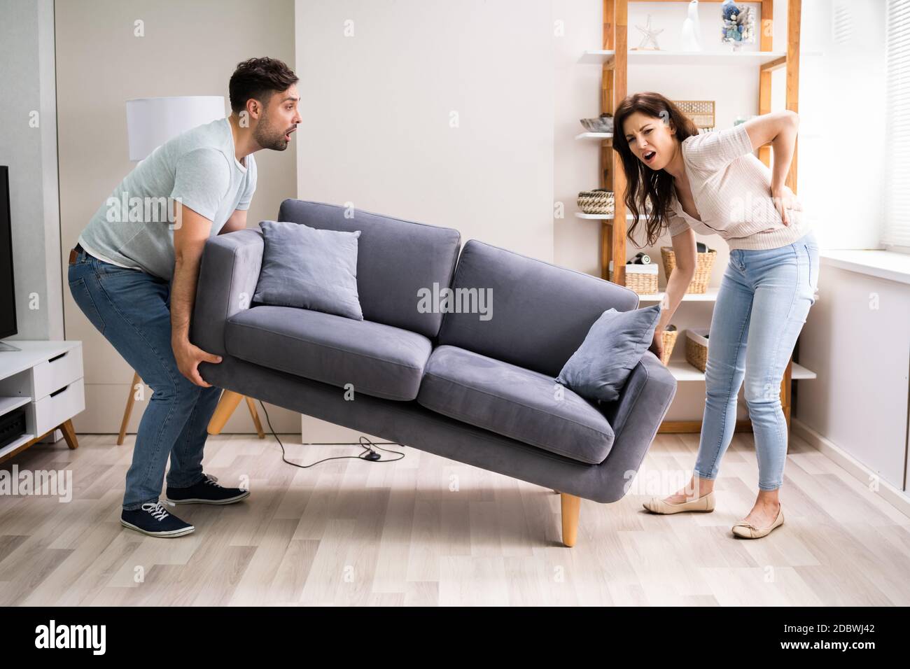 Person Lifting Heavy Furniture Couch Having Back Injury Stock Photo - Alamy