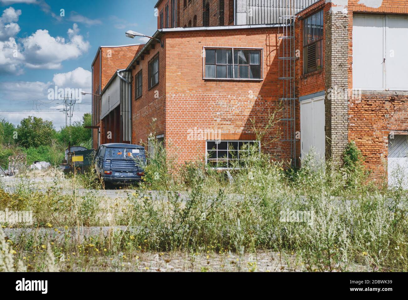 An old abandoned industrial site with a red brick building with a rusty ...