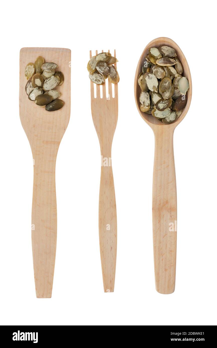 Wooden spoon, fork, paddle with pumpkin seed, isolated on white ...