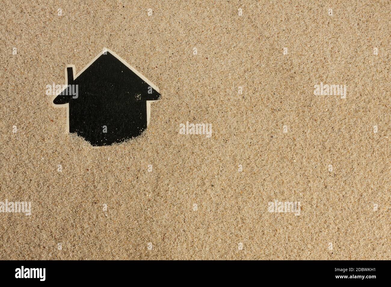 Pointer house in the sand, can be used as background Stock Photo - Alamy