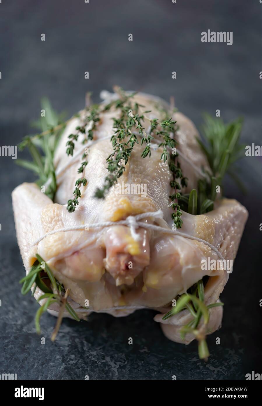 closeup of raw unccoked chicken with aromatic herbs Stock Photo - Alamy
