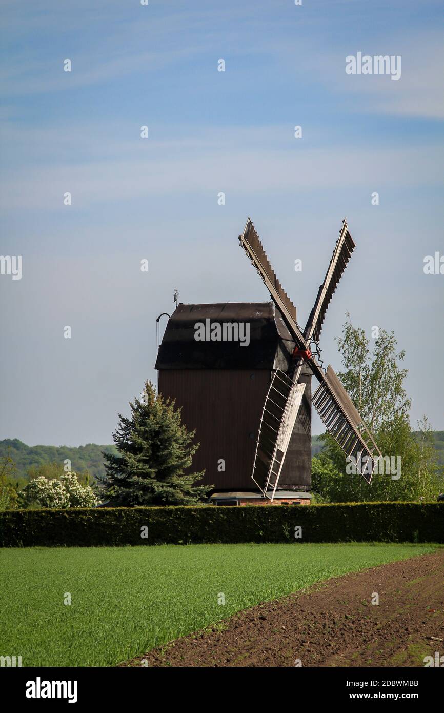 View of a well-preserved old post mill Stock Photo - Alamy