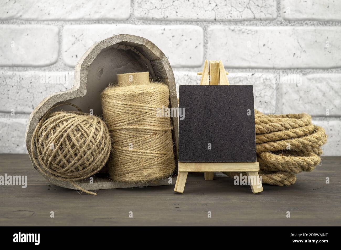 Assorted balls of hemp twine and string with skeins of rope and slate ...