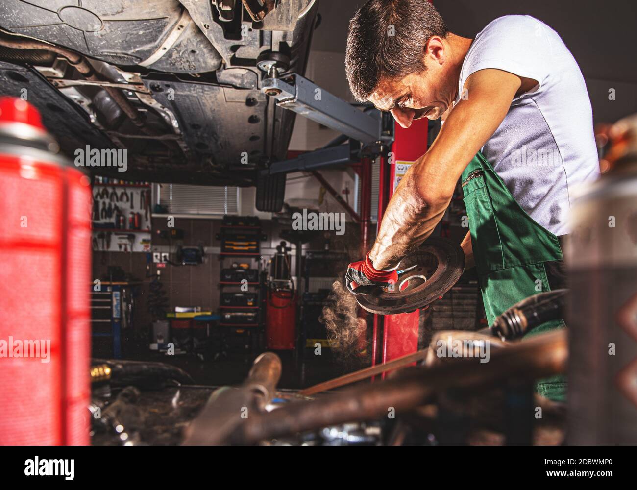 Professional mechanic man fixing the rusty car bearing Stock Photo - Alamy