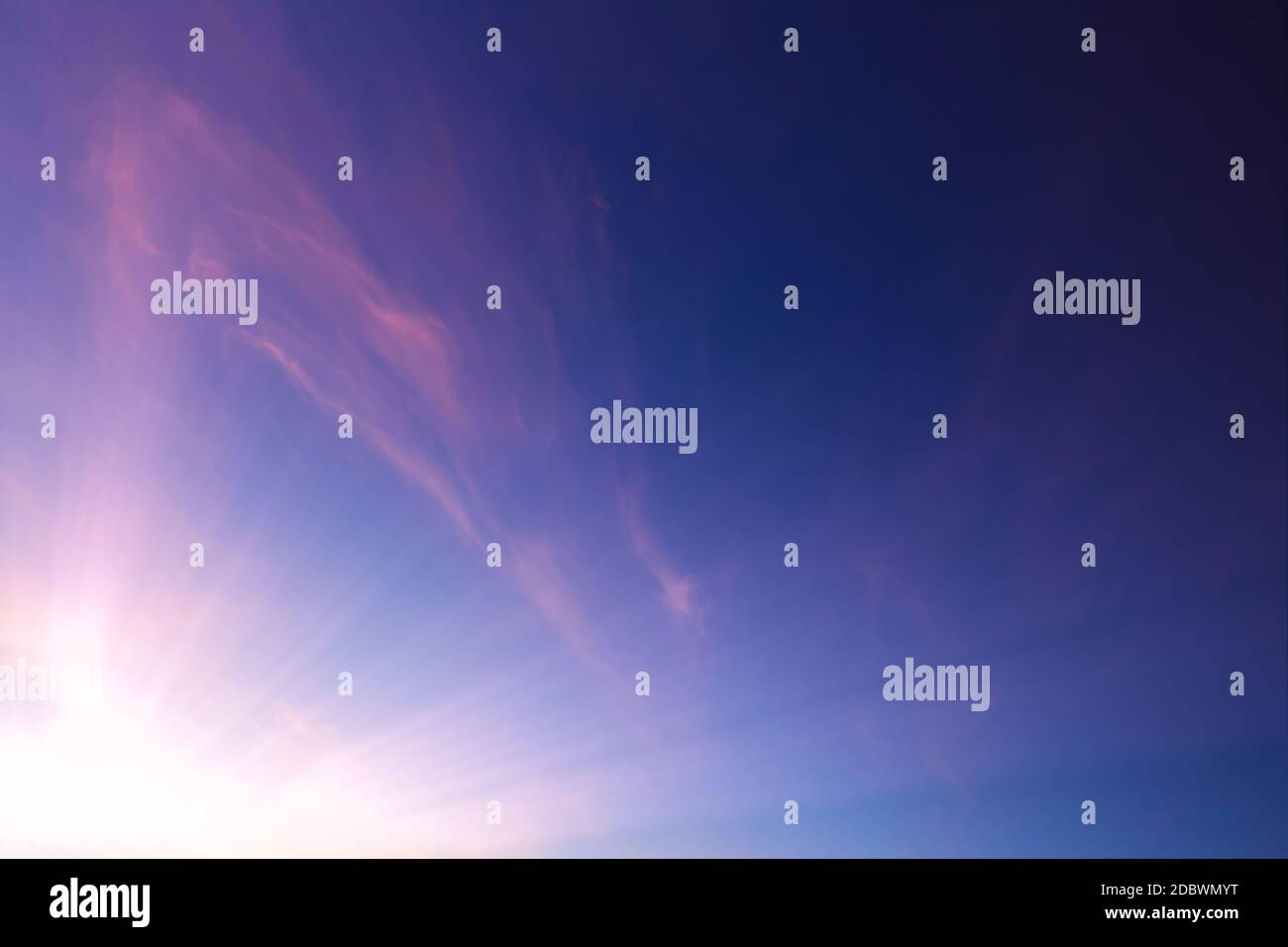Pink wispy clouds in a blue sky sunset Stock Photo - Alamy