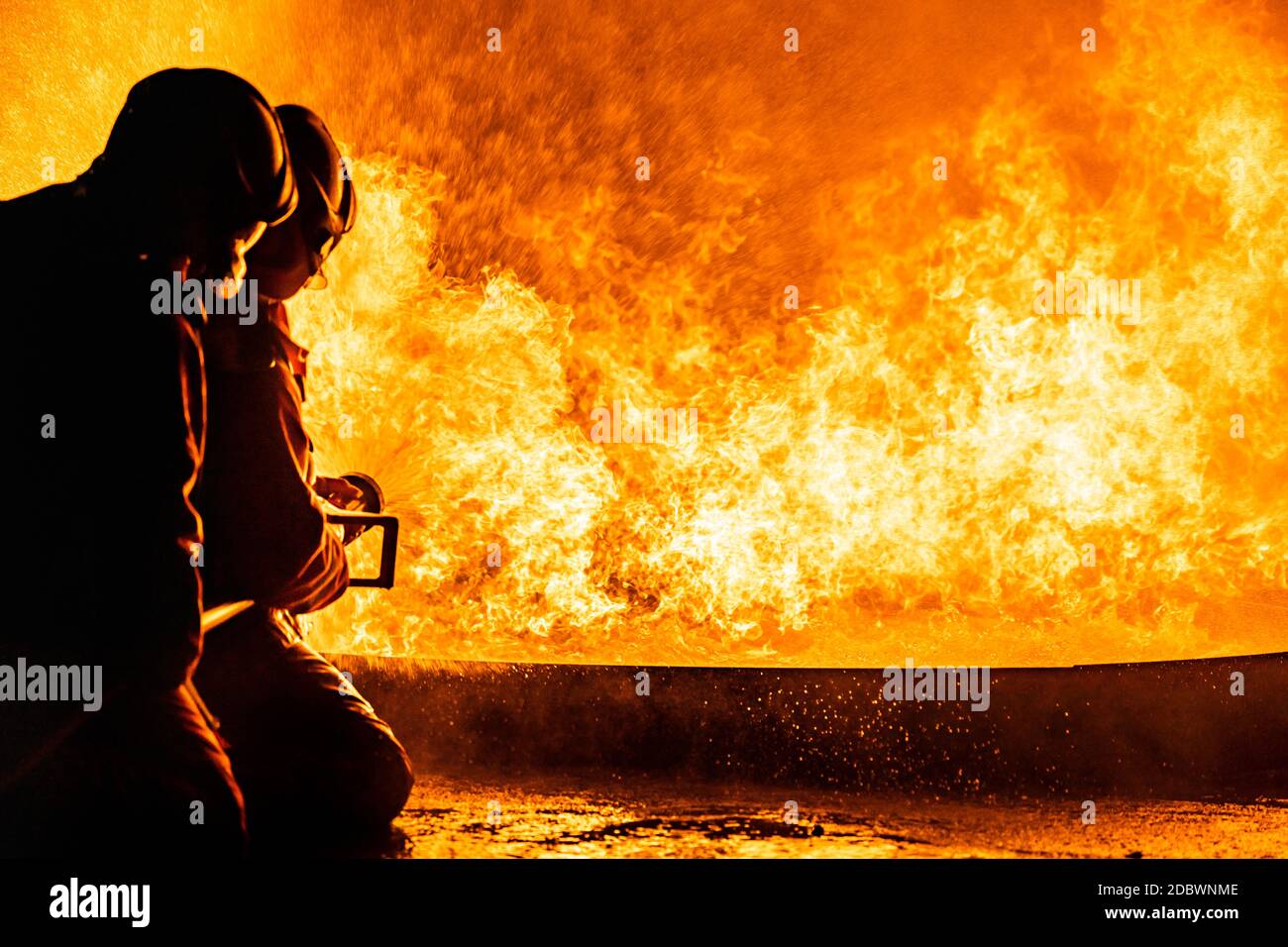 Firefighters using Twirl water fog type fire extinguisher to fighting ...