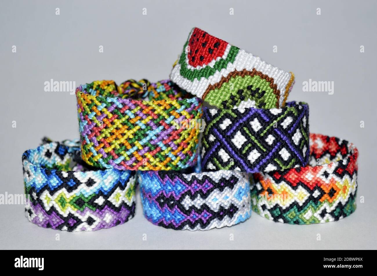 Selective focus of multi-colored woven DIY friendship bracelets ...