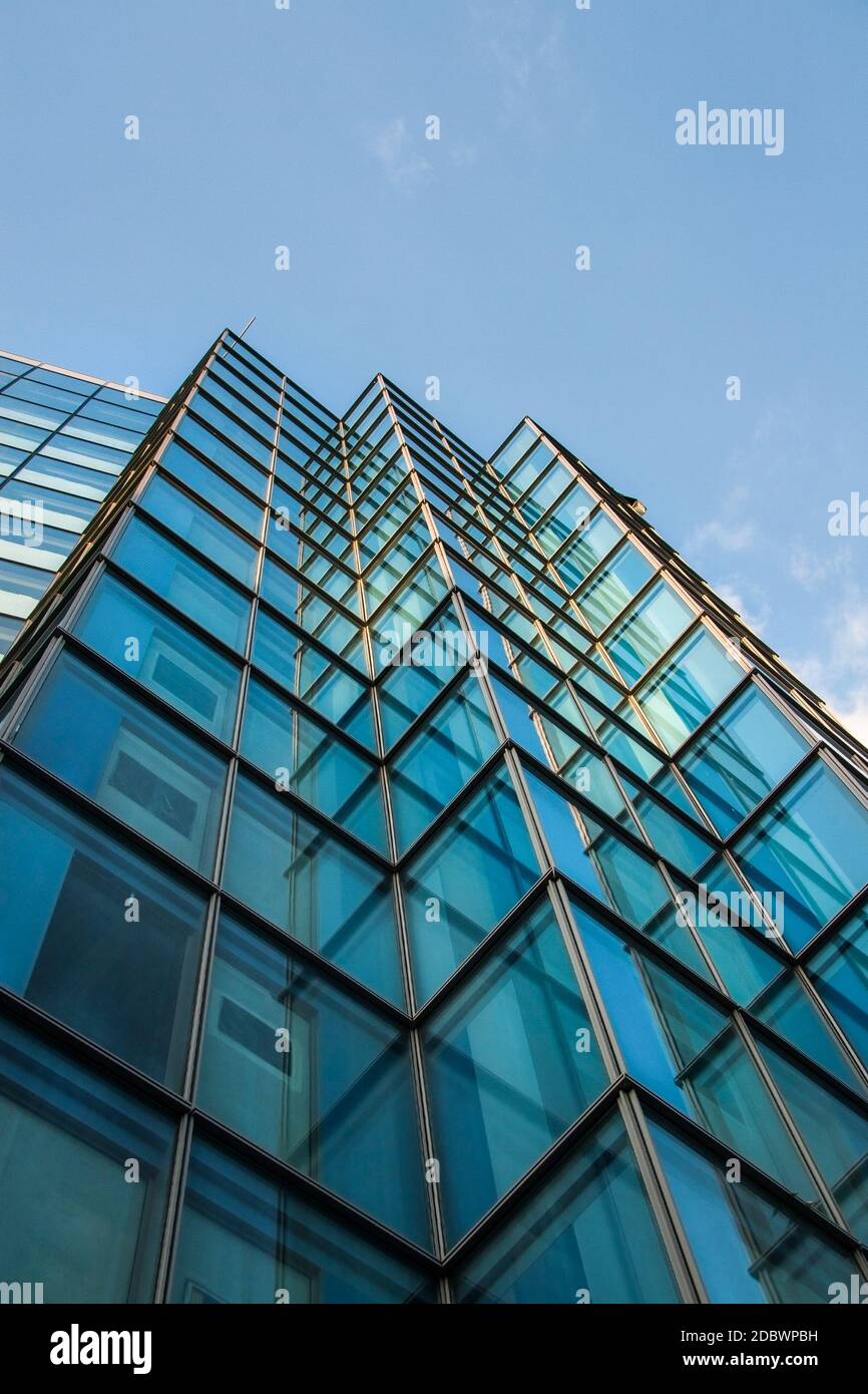 Square windows of modern steel and glass office building rising to ...