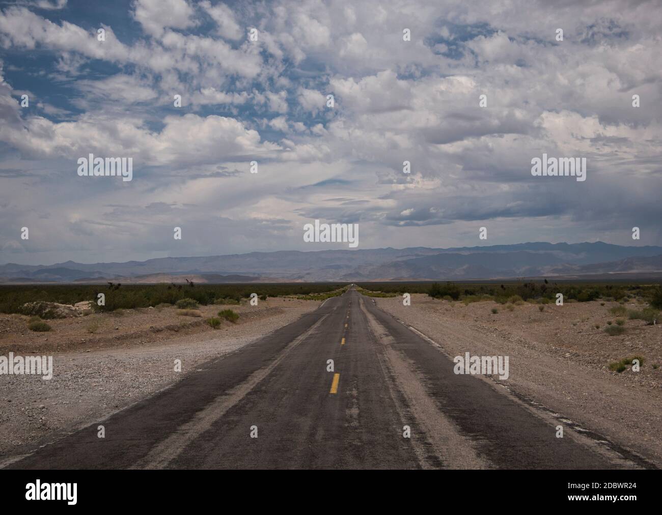 Thick rain clouds over a badly paved road Stock Photo - Alamy