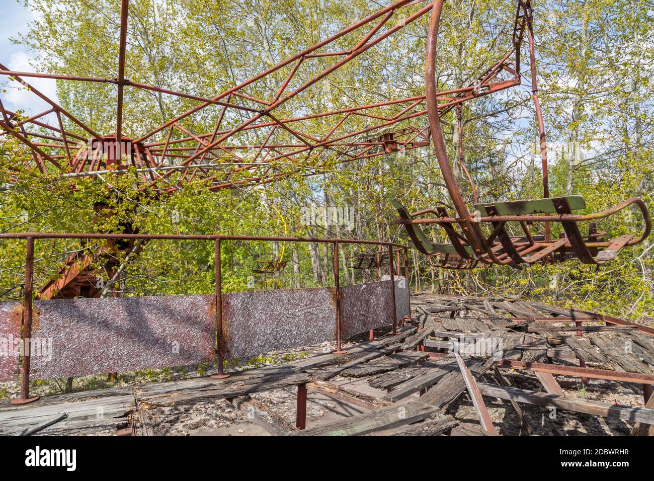 Old broken rusty metal radioactive children's electric wheel abandoned ...