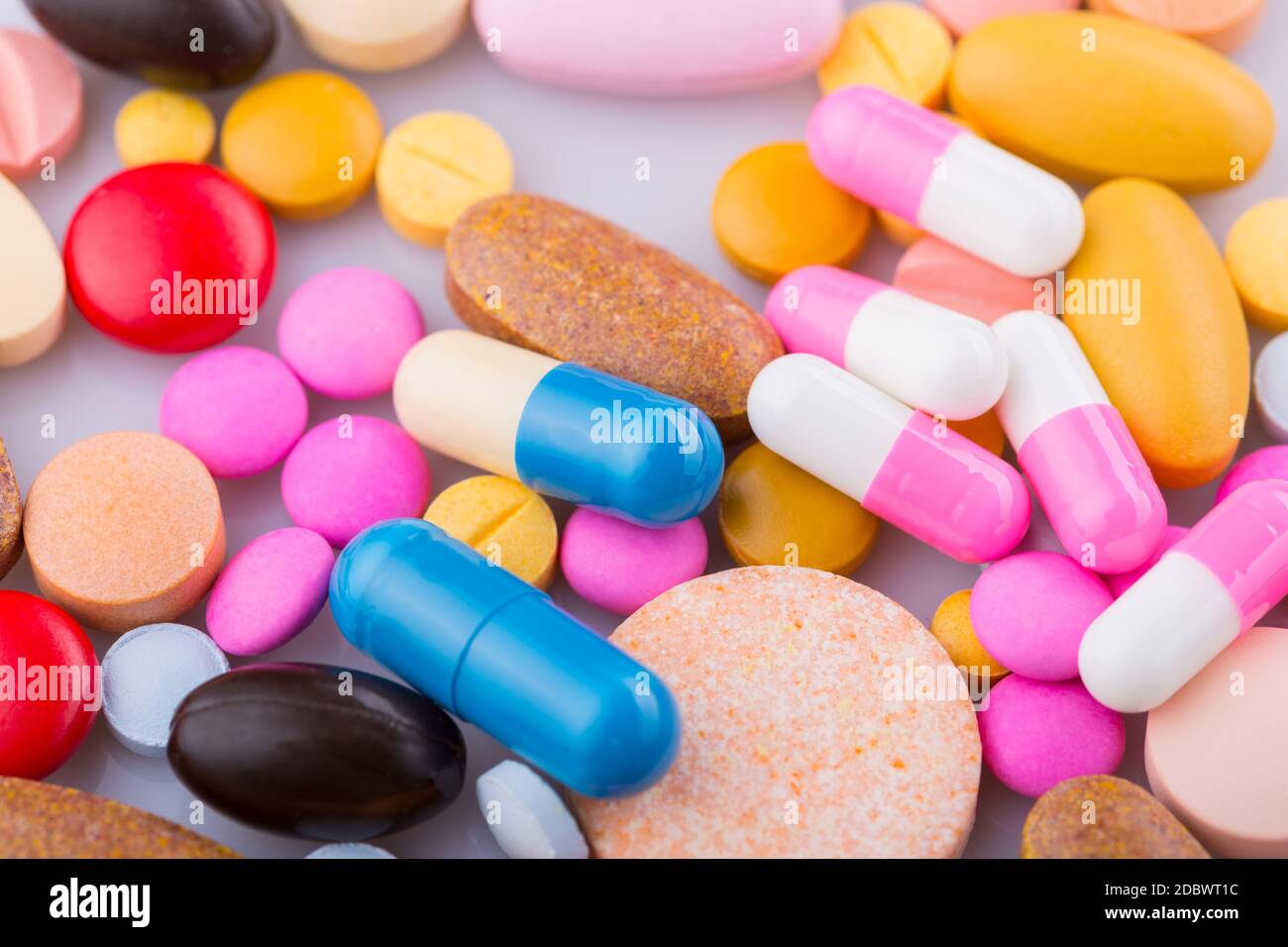 Tablets pills capsule heap mix therapy drugs, over a white background ...