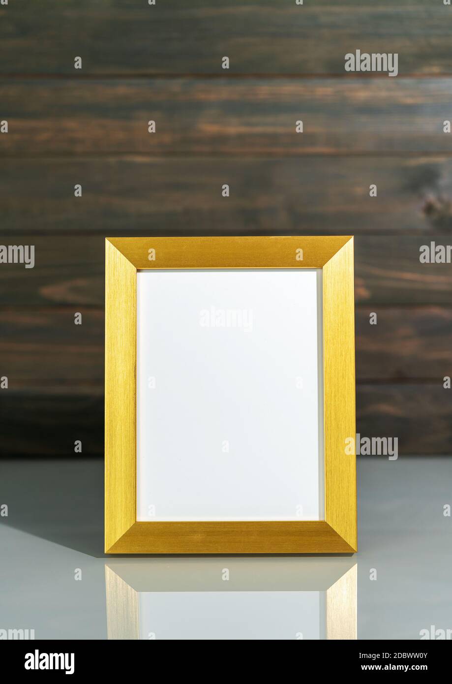 Picture golden frame mock up over table with wood wall background Stock ...