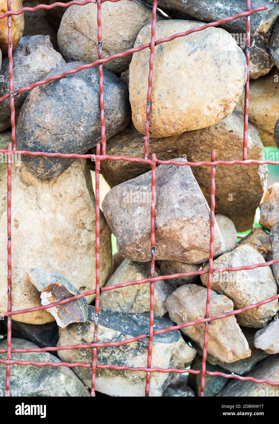 The fence of the wall made of stone The stone wall is tied around with ...