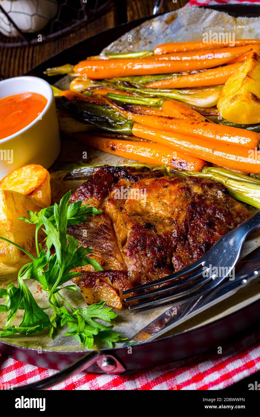 grilled neck chops with caramelized vegetables Stock Photo - Alamy