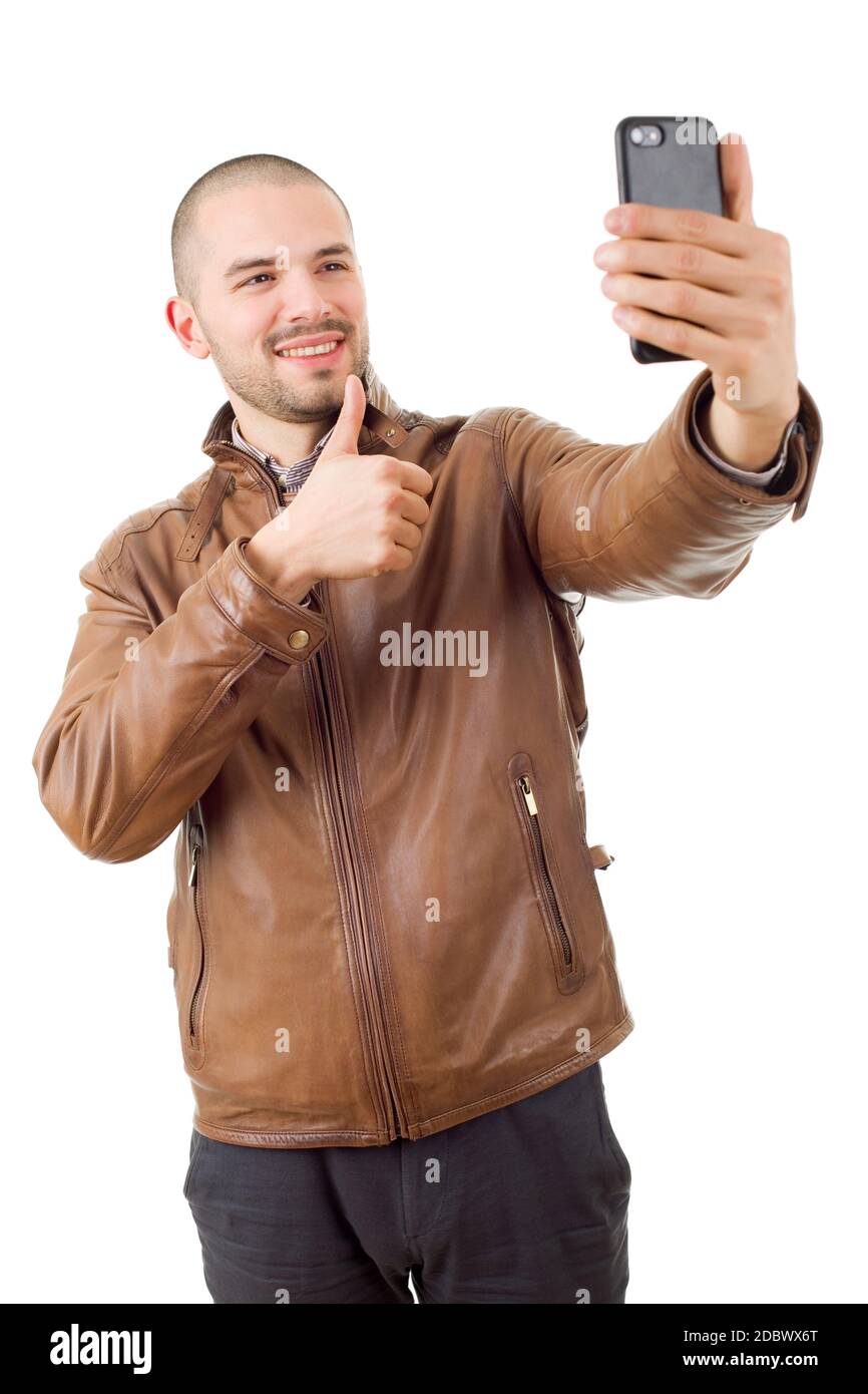 man taking selfie photo with mobile phone camera posing happy and successful isolated on white ...