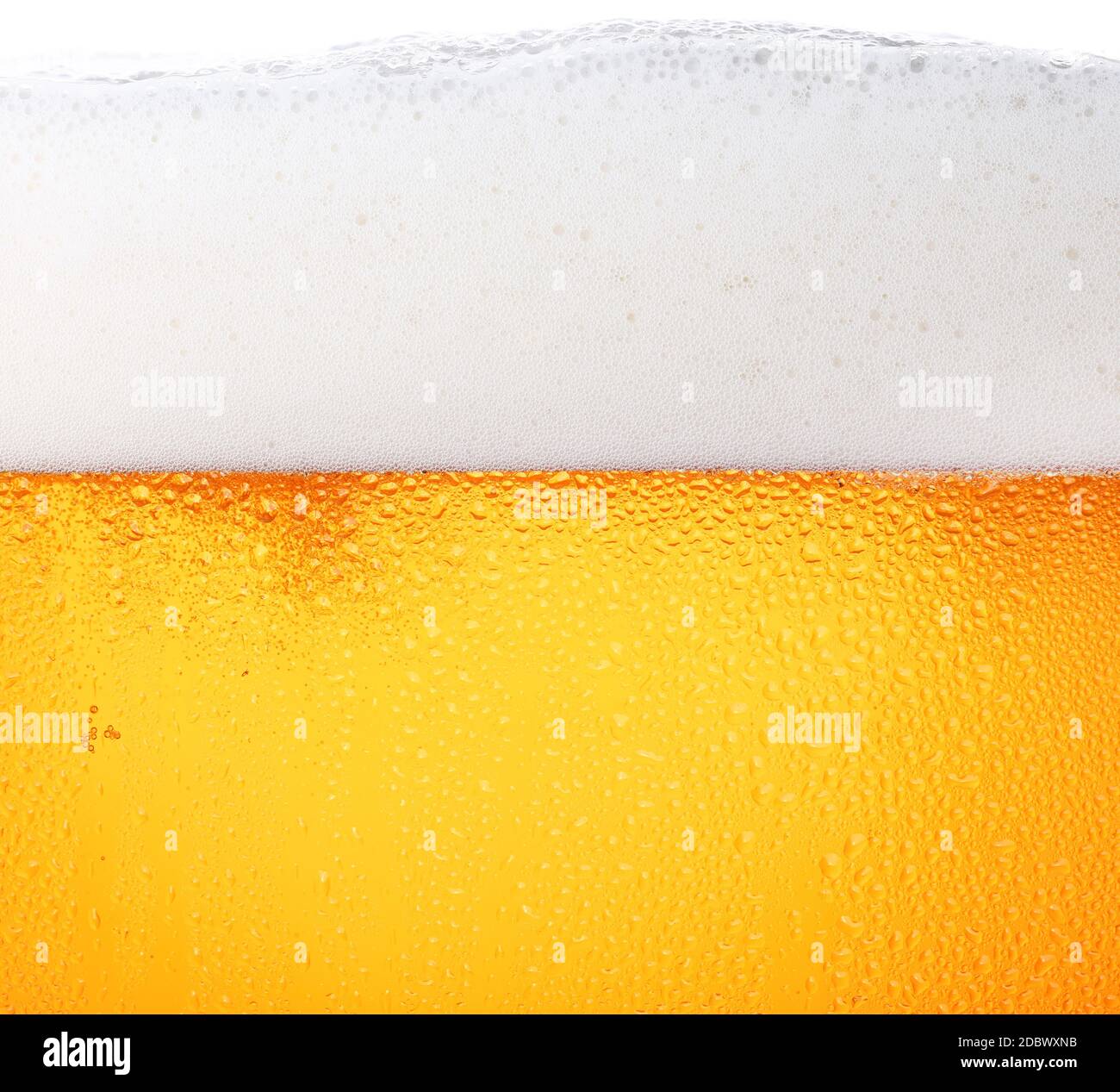 Close up background texture of pouring lager beer with bubbles and ...