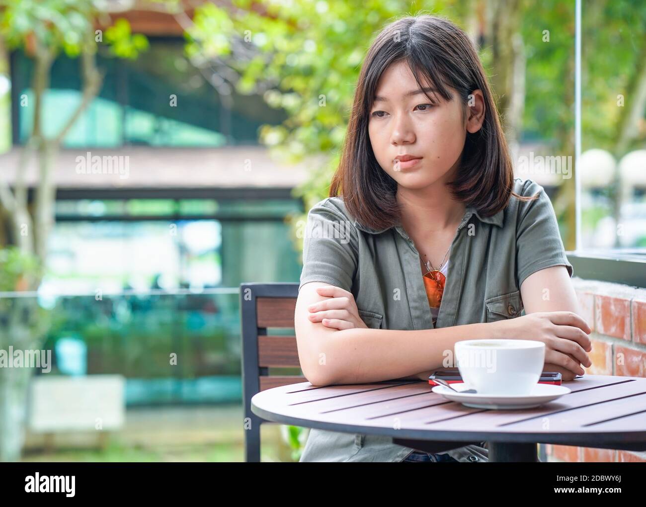 Pretty woman sitting in a cafe terrace with coffee cup Stock Photo - Alamy