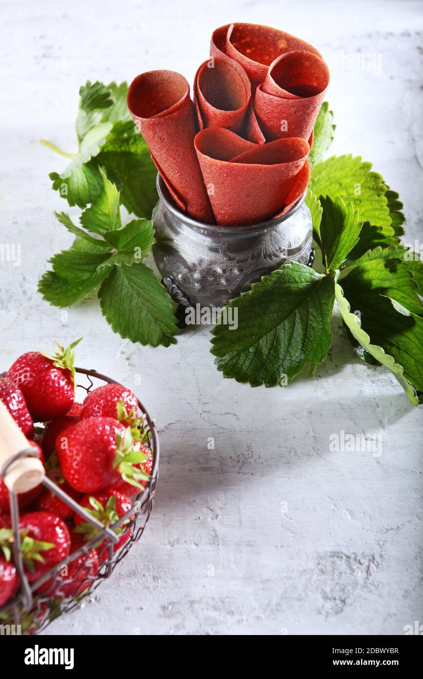 Strawberry pastille is rolled into a cone shape in a vintage vase ...