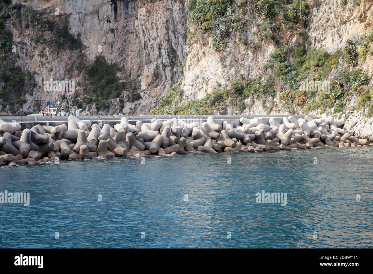 Concrete pylons form a wall that was built for flood protection and ...