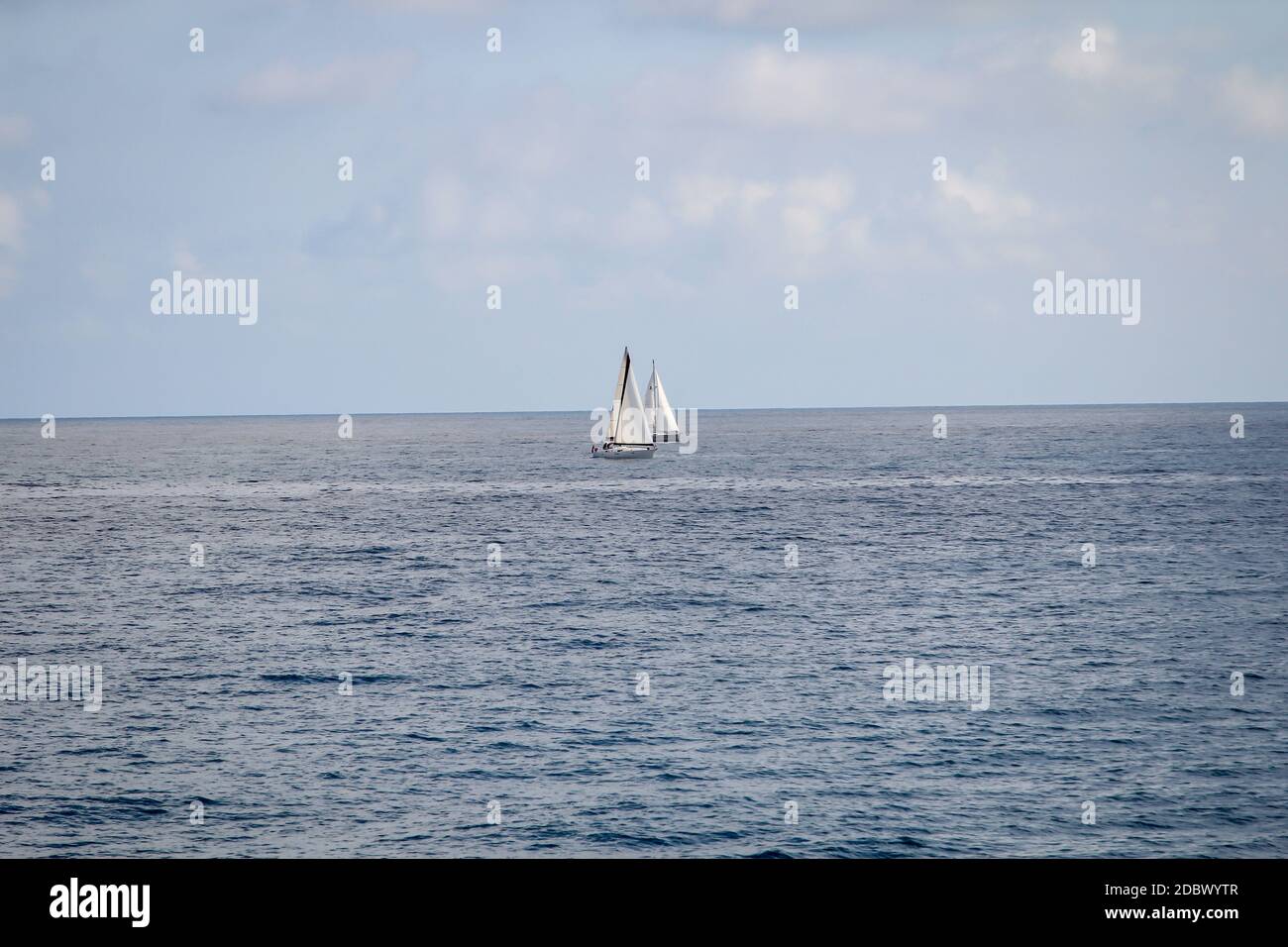 two sailing boats go on the open sea Stock Photo - Alamy