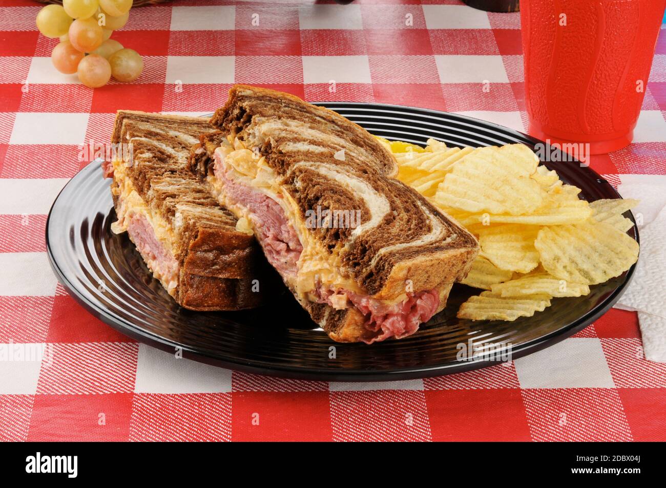 A reuben sandwich with potato chips Stock Photo - Alamy