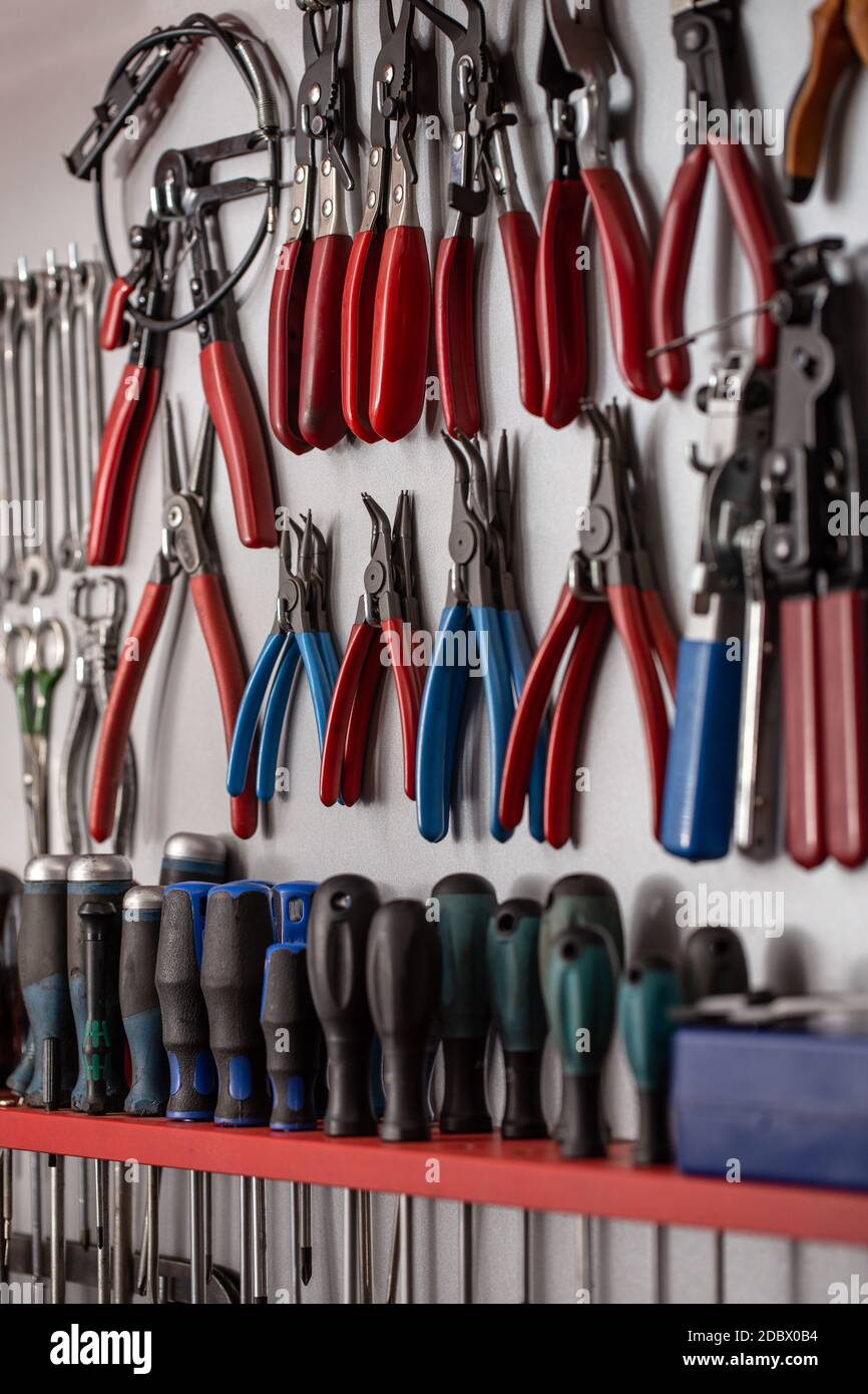 Professional work tools hanging on steel wall as background hi-res ...