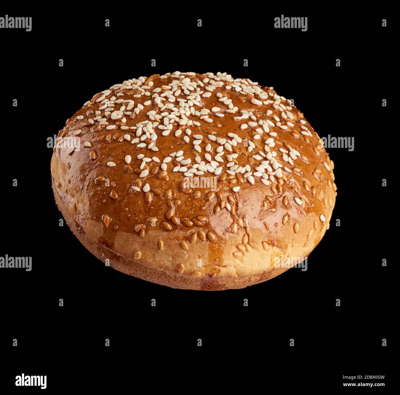 baked round bun with sesame seeds isolated on black background ...