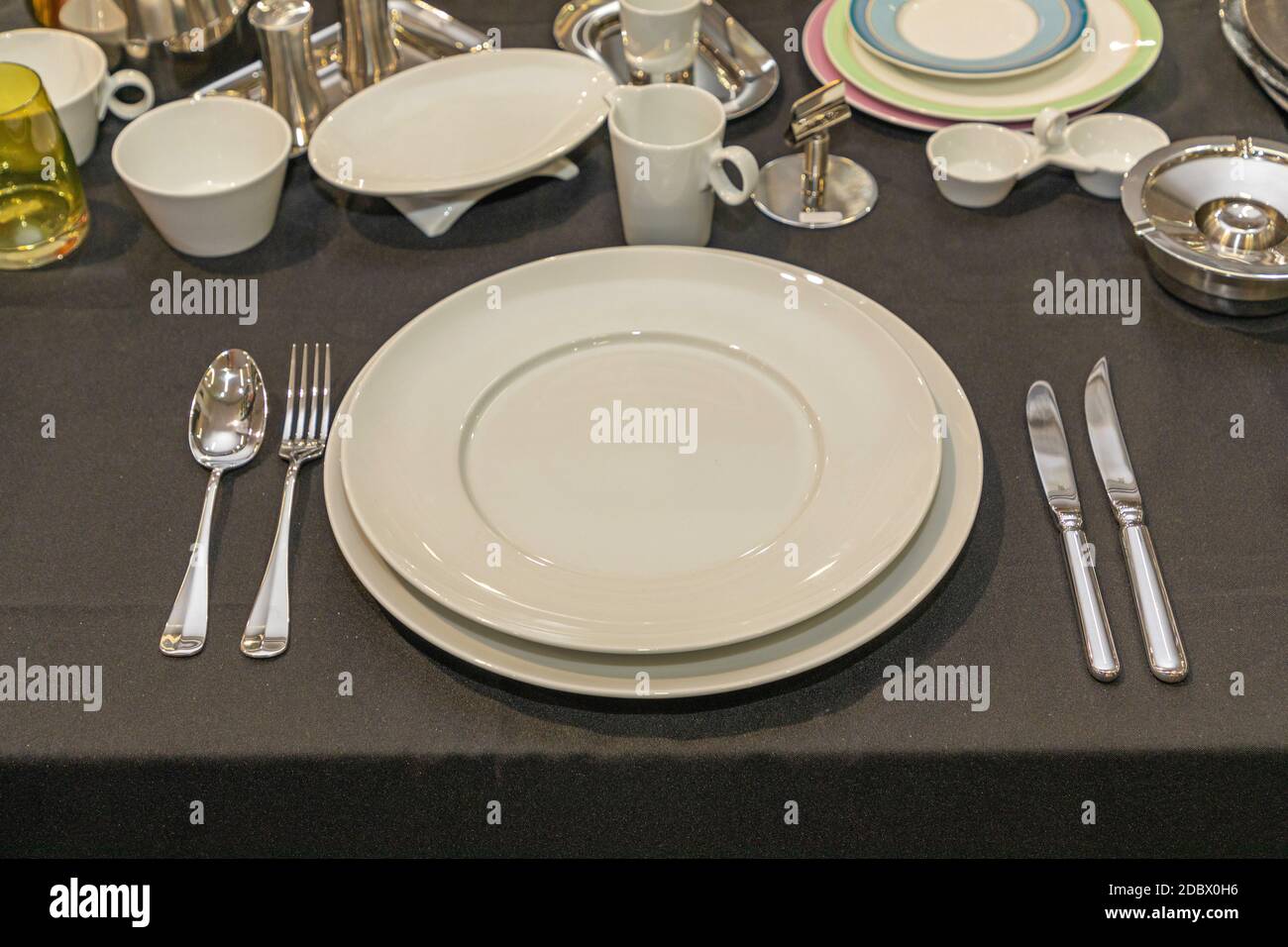 Ceramic Plates at Black Table Setup Stock Photo - Alamy