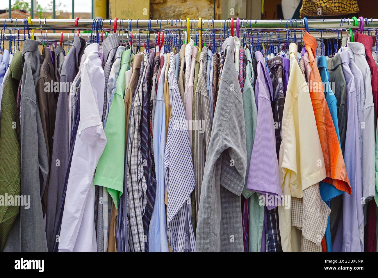 Used shirts hanging at clothes rails Stock Photo - Alamy