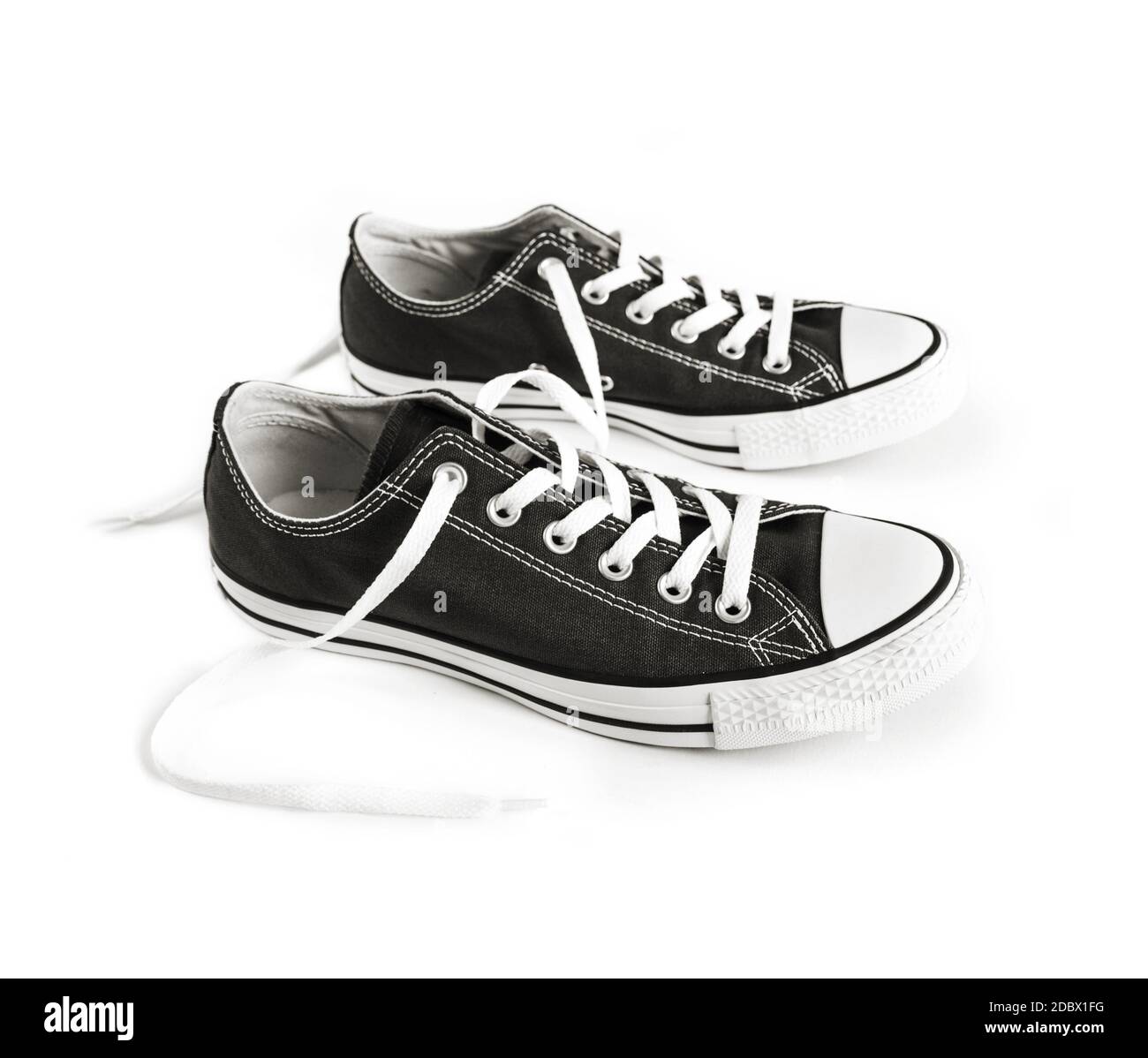 Black generic sneakers isolated on white background Stock Photo - Alamy