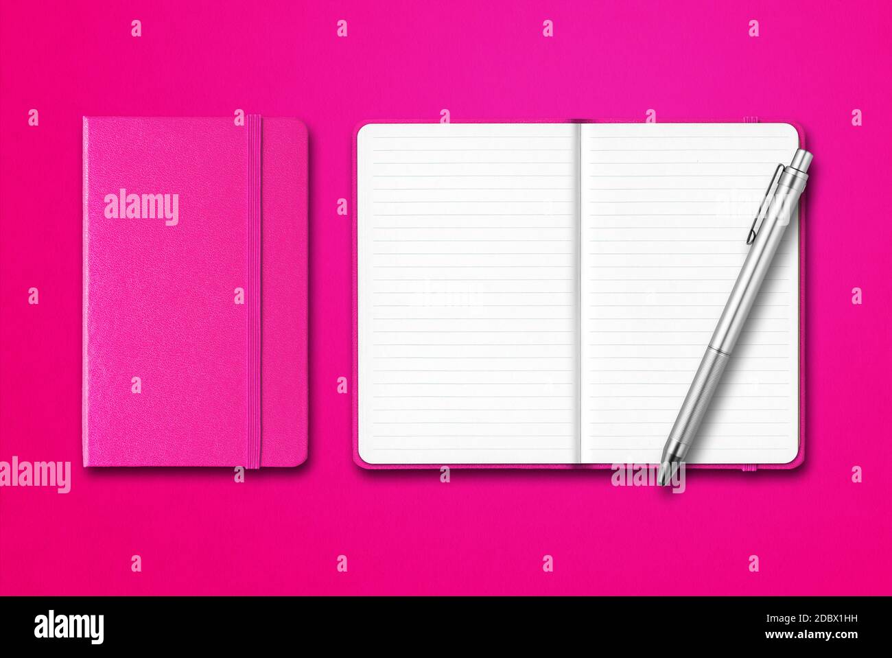 Pink closed and open lined notebooks with a pen isolated on colorful ...