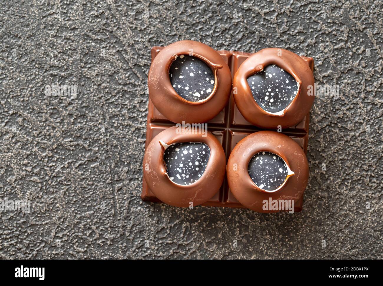 Handcrafted chocolate candies on black background Stock Photo - Alamy