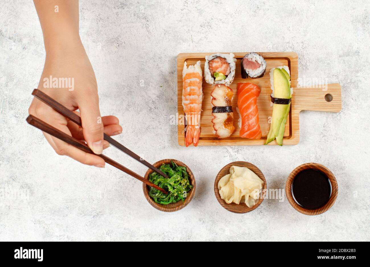 Top view of hand taking roll with chopsticks from a plate Stock Photo ...