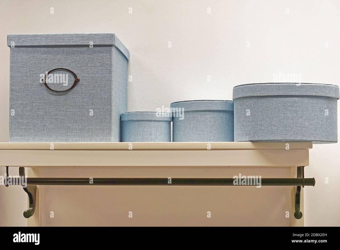 Decorative storage boxes at shelf in home Stock Photo - Alamy