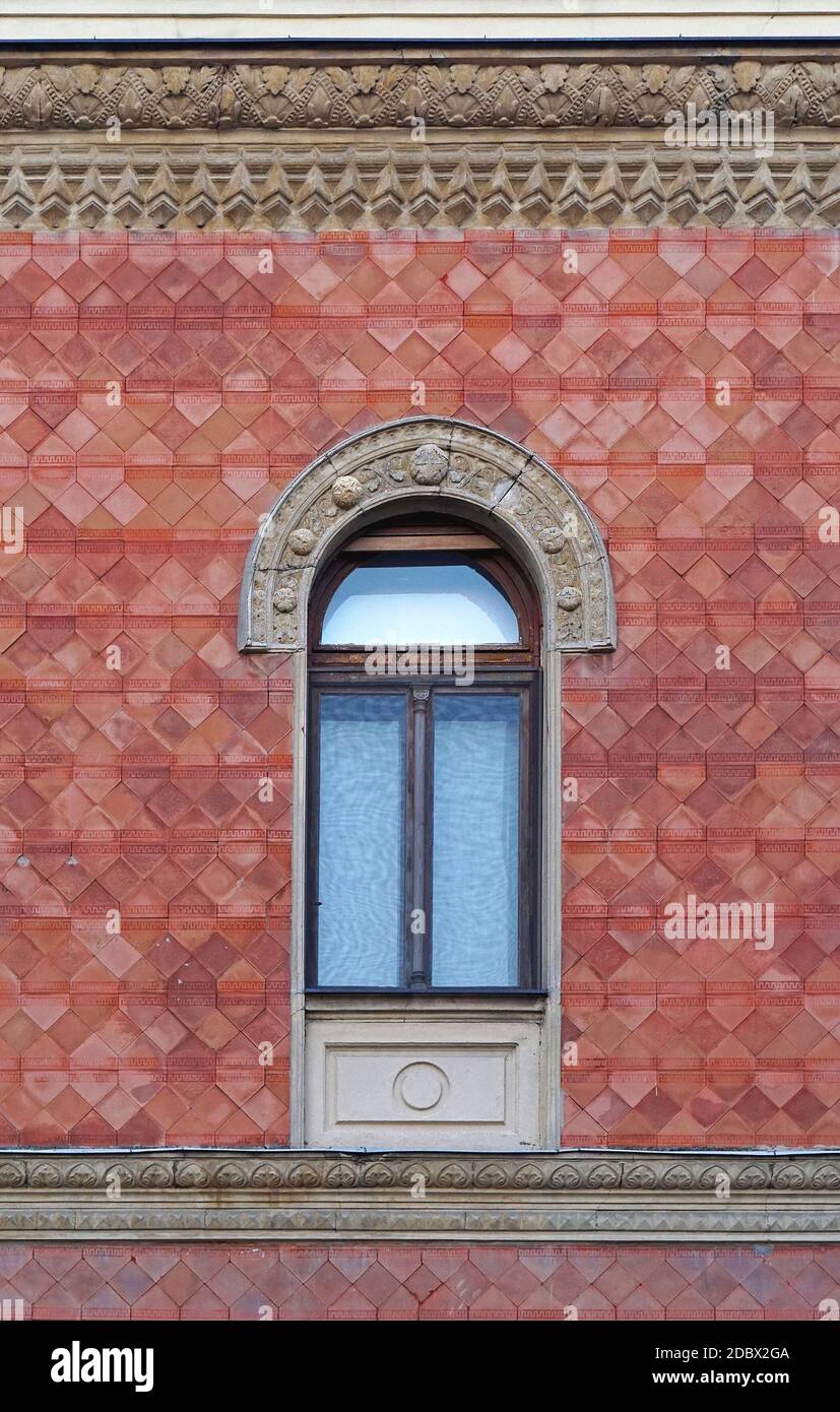Arch window at classic style building with red facade Stock Photo - Alamy