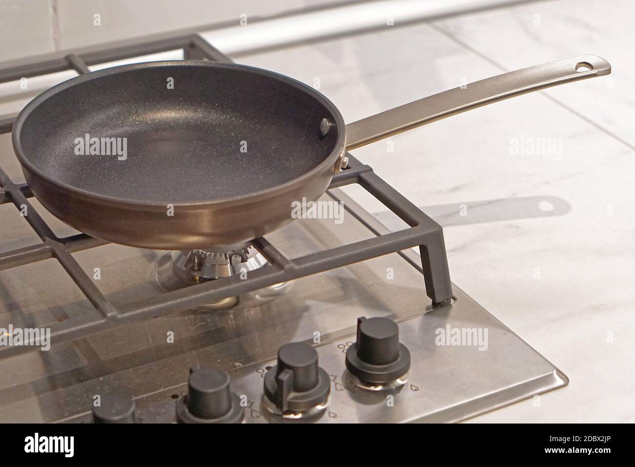 Non stick pan at gas burning stove Stock Photo - Alamy